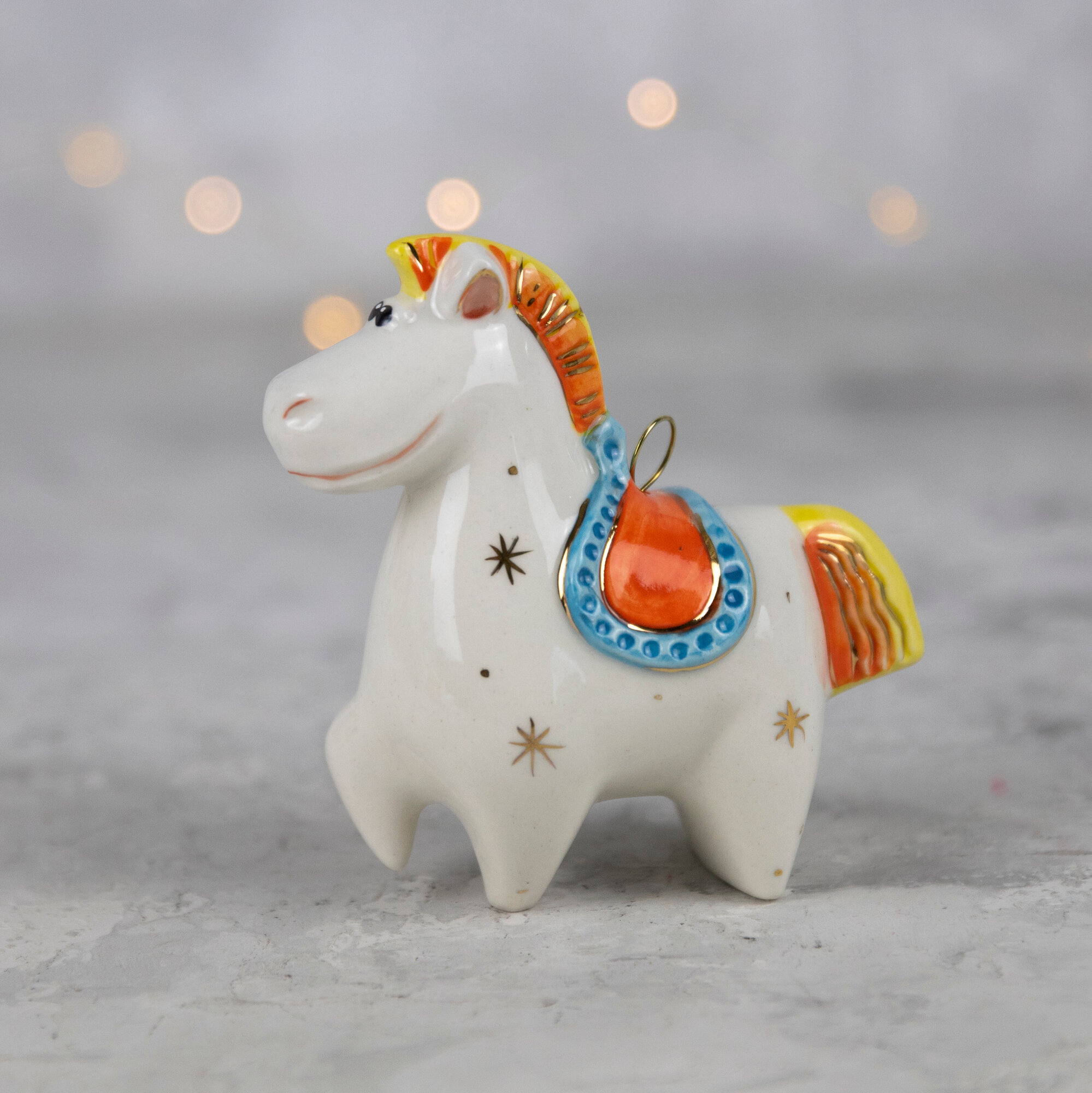 Ёлочная игрушка "Коник" c рыже-голубым седлом. Фарфор