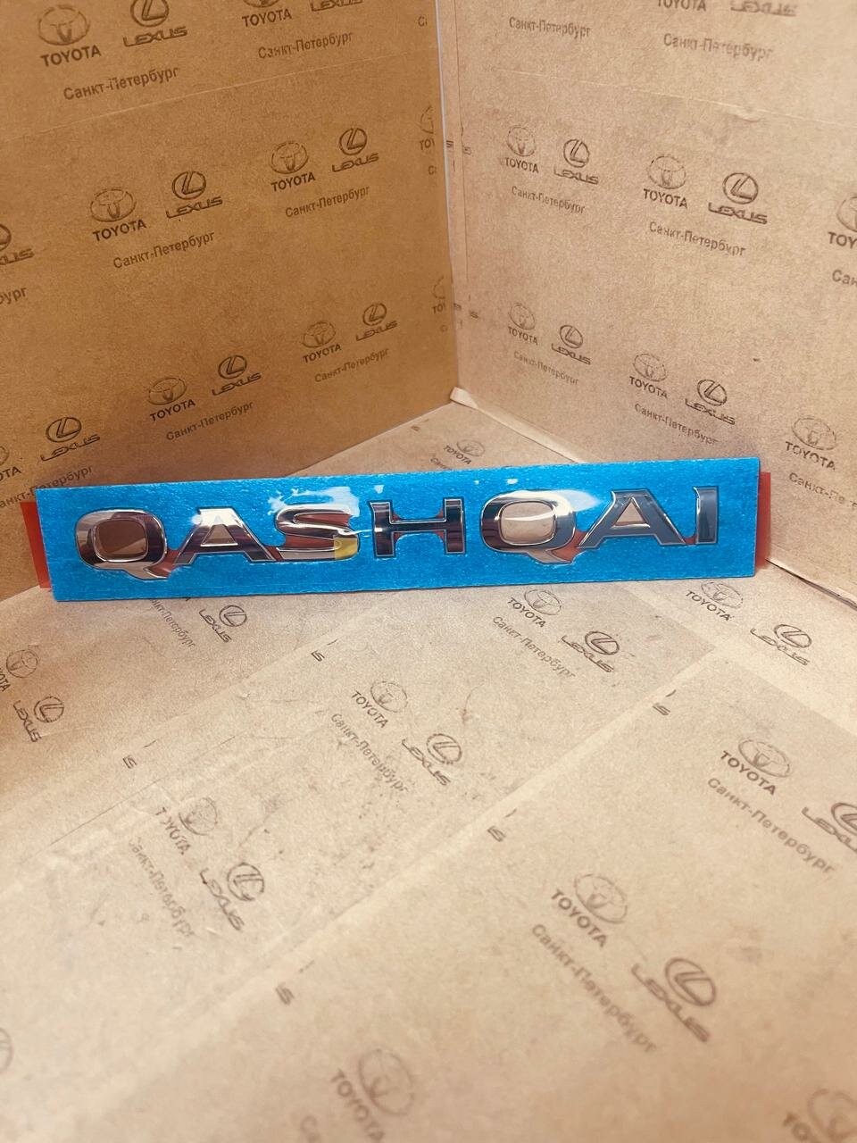 908924EM0A Эмблема крышки багажника Nissan Qashqai