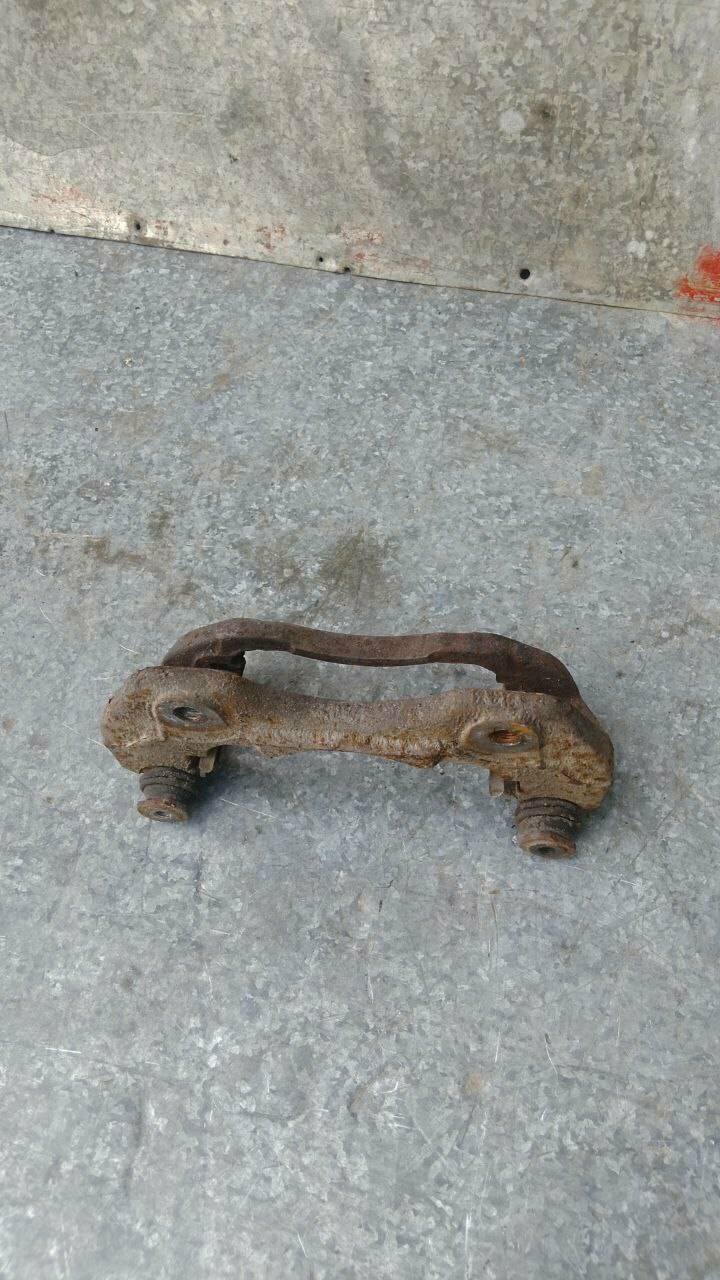 Скоба суппорта передняя левая Mitsubishi Lancer 9 (2003 - 2010)