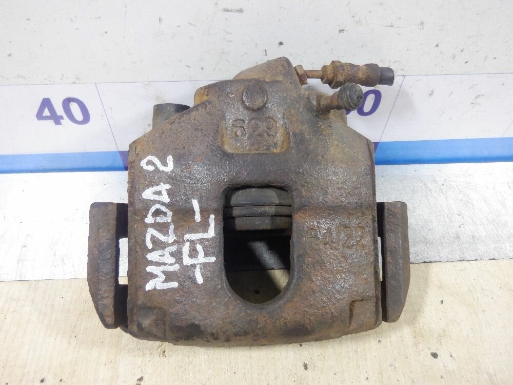 Суппорт передний левый Mazda 2