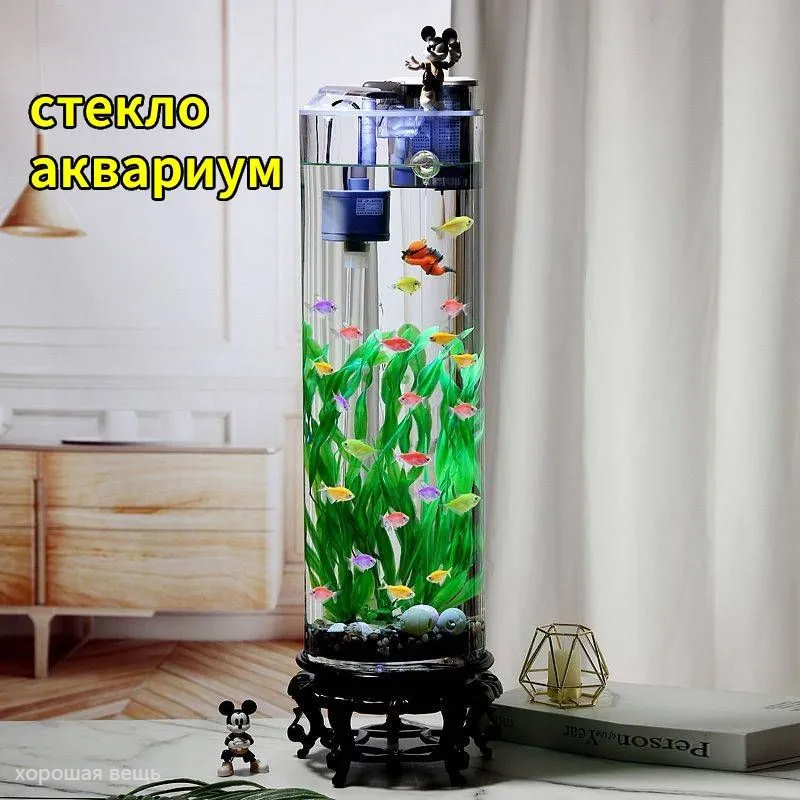 Панорамный цилиндрический аквариум из сверхпрозрачного стекла. Полная экосистема: освещение, аэрация, фильтрация, минимальный уход. Готовое решение для гостиной или офиса.