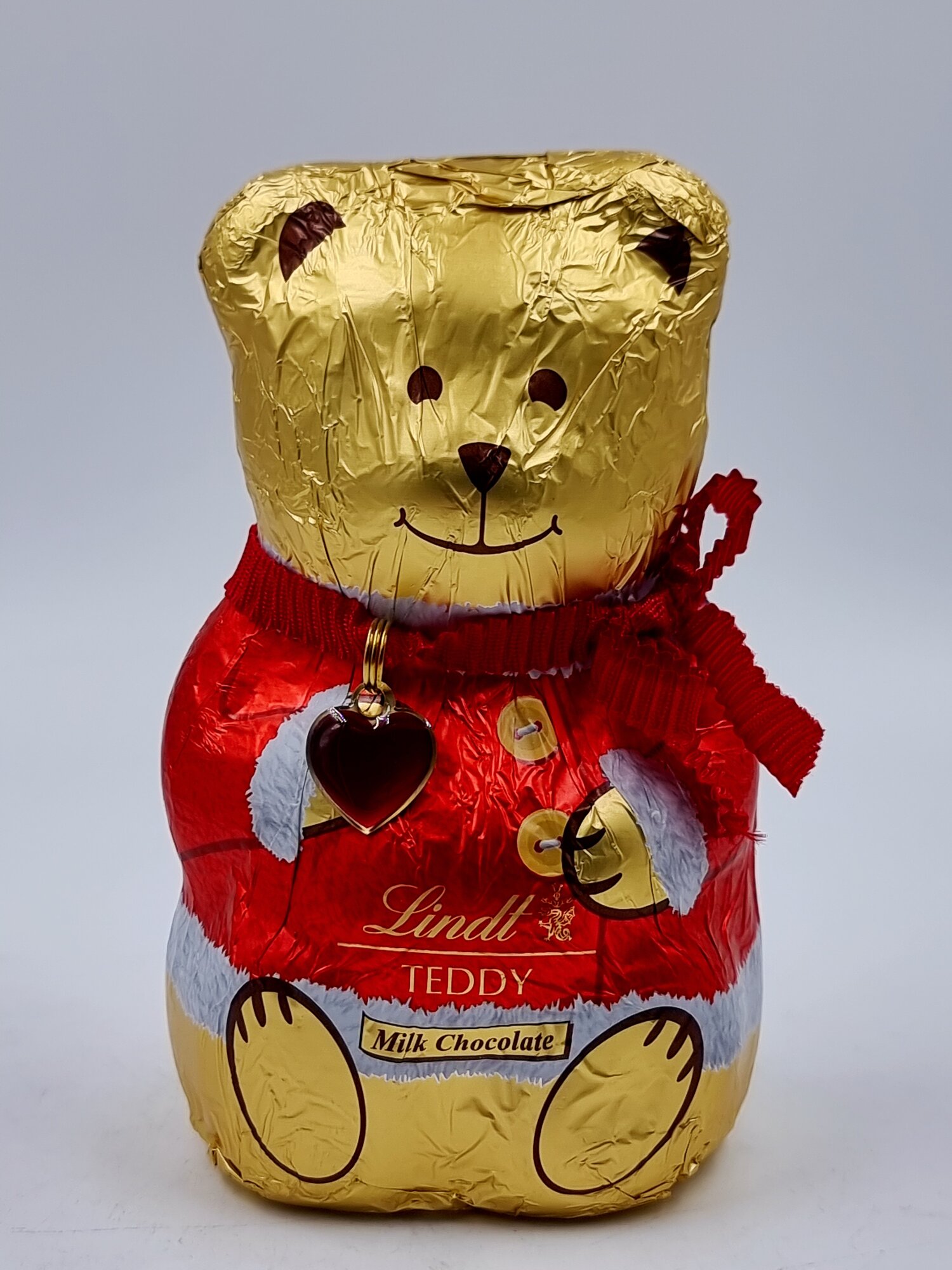 Lindt Teddy Шоколад молочный в форме Мишки, красный/розовый 100 г 1 шт (Германия)