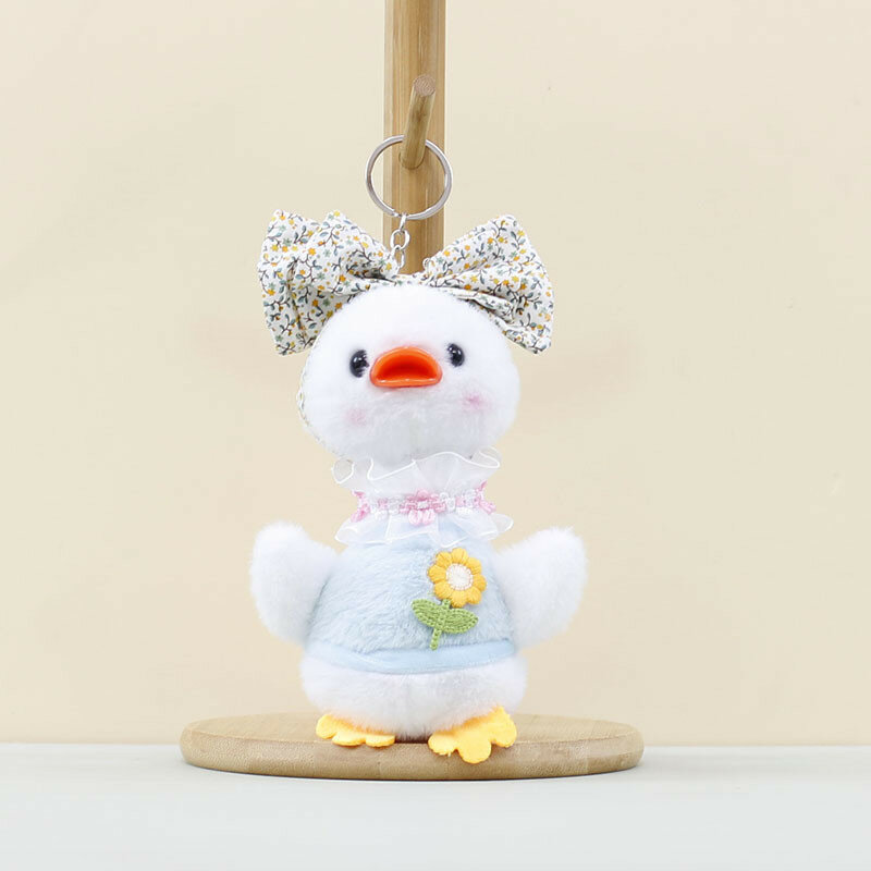 Small toy with yellow bow for bag accessory and playroom decor, blue bow