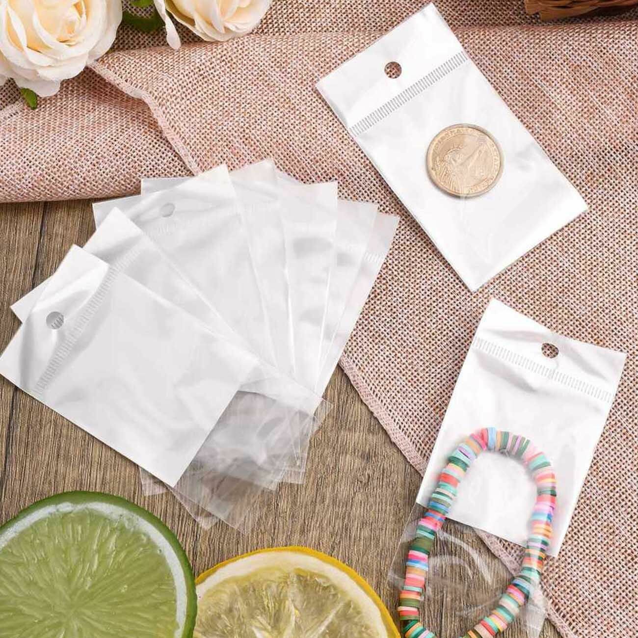 500 пакетов 5х5,5+4 см упаковочных прозрачных с подвесом, жемчужным белым фоном и клеевым клапаном