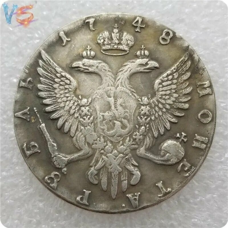 Это серебряная монета периода царской России, отчеканенная в 1748 году.