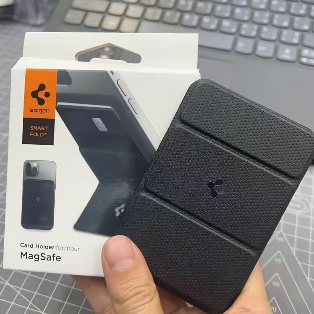Картхолдер Spigen AMP02746. Черного цвета с функцией подставки.