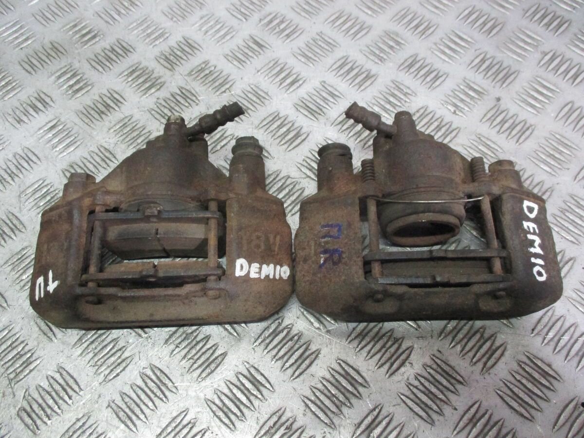 Суппорт тормозной передний Mazda Demio 2000-2007