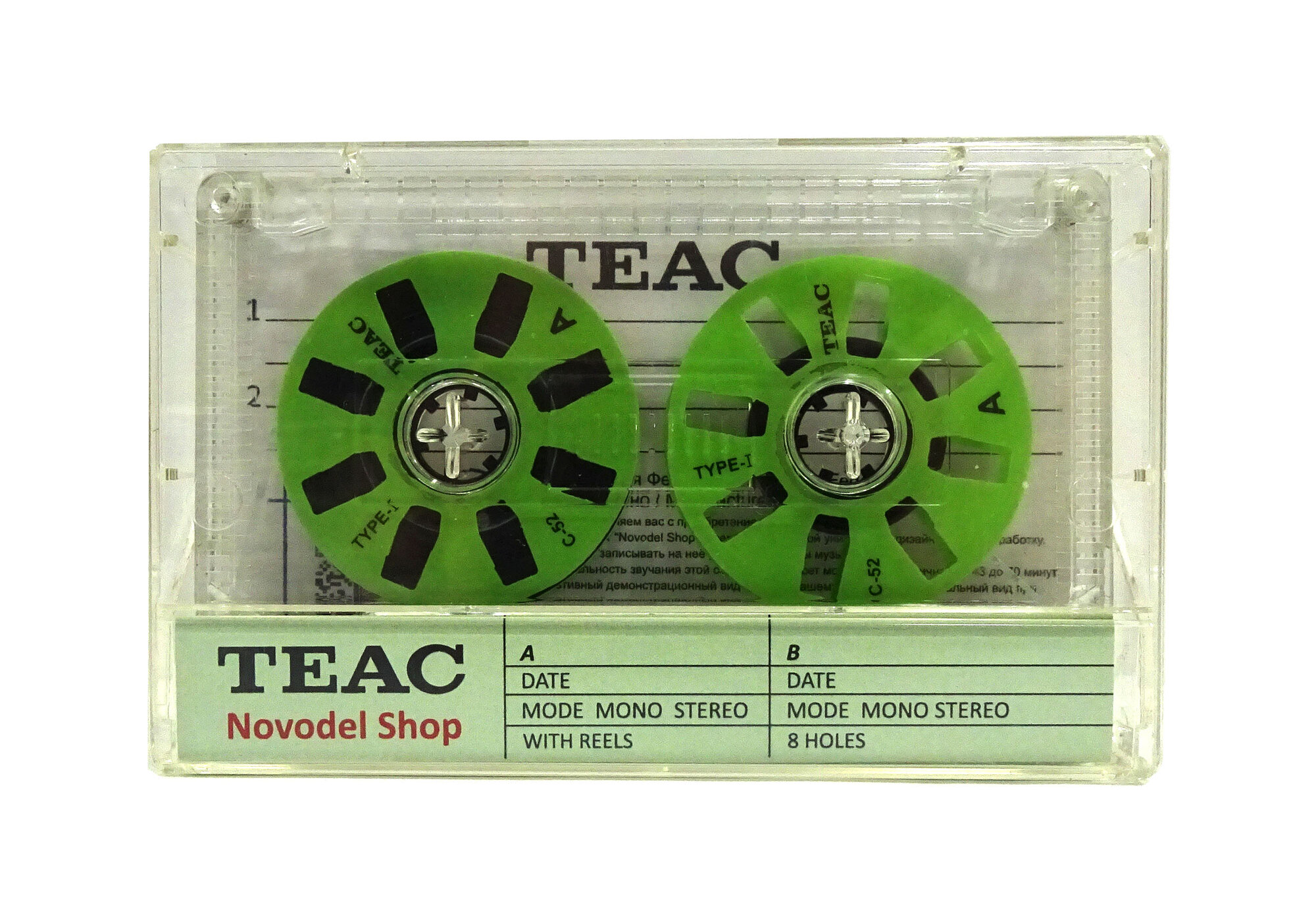 Аудиокассета "TEAC" с зелёными катушками и логотипом "Novodel Shop" c 8 отверстиями