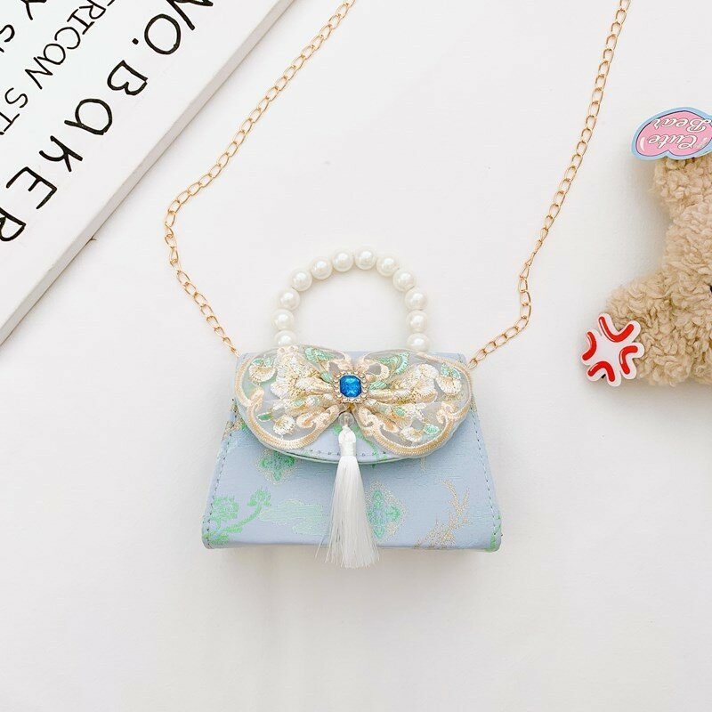 Trendy yellow pearl bow shoulder bag for kids with stylish chain and breezy fabric blue tassel