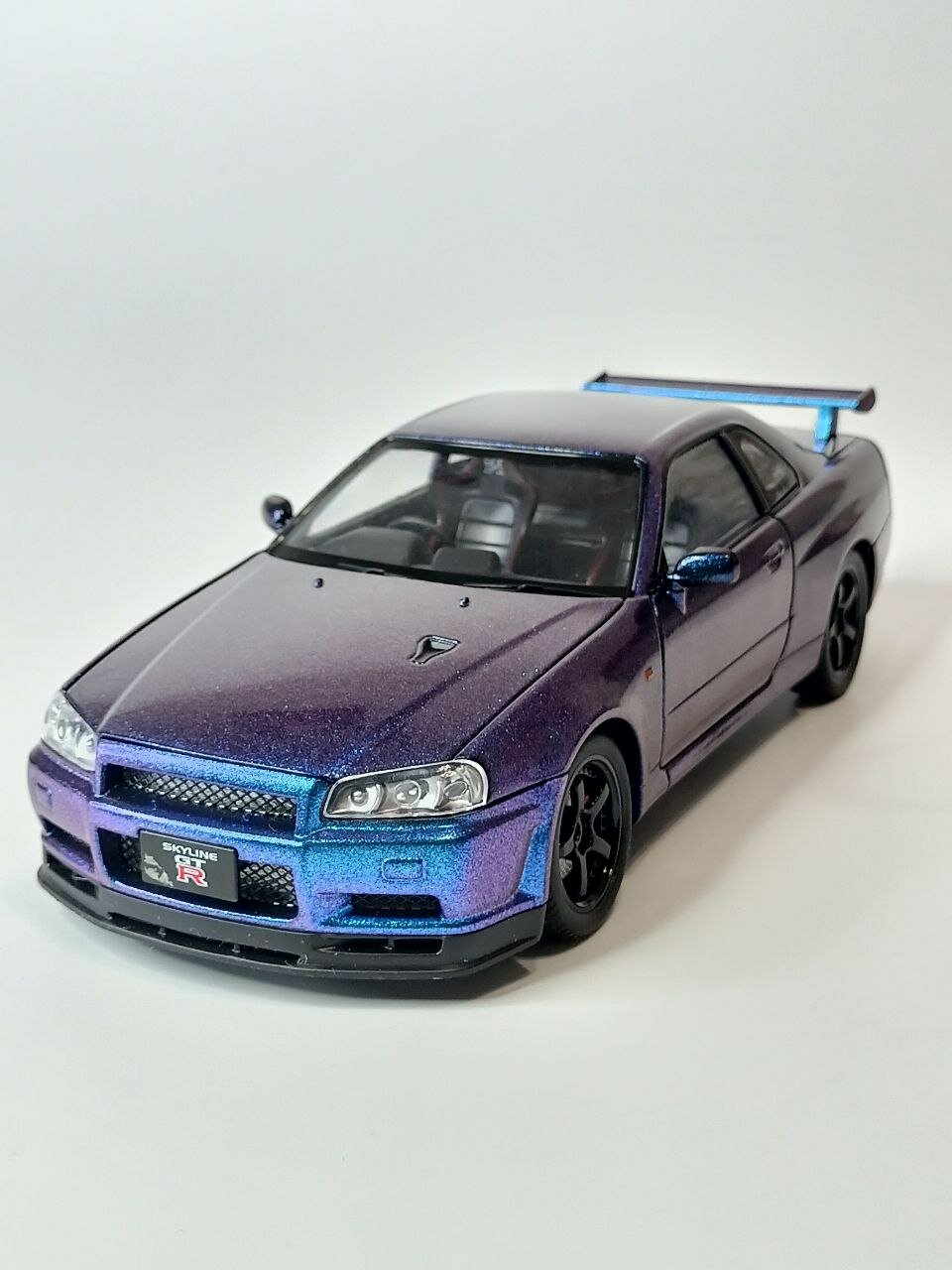 Коллекционная машинка NISSAN Skyline GT-R R34 металлическая масштаб 1:24 фиолетовый
