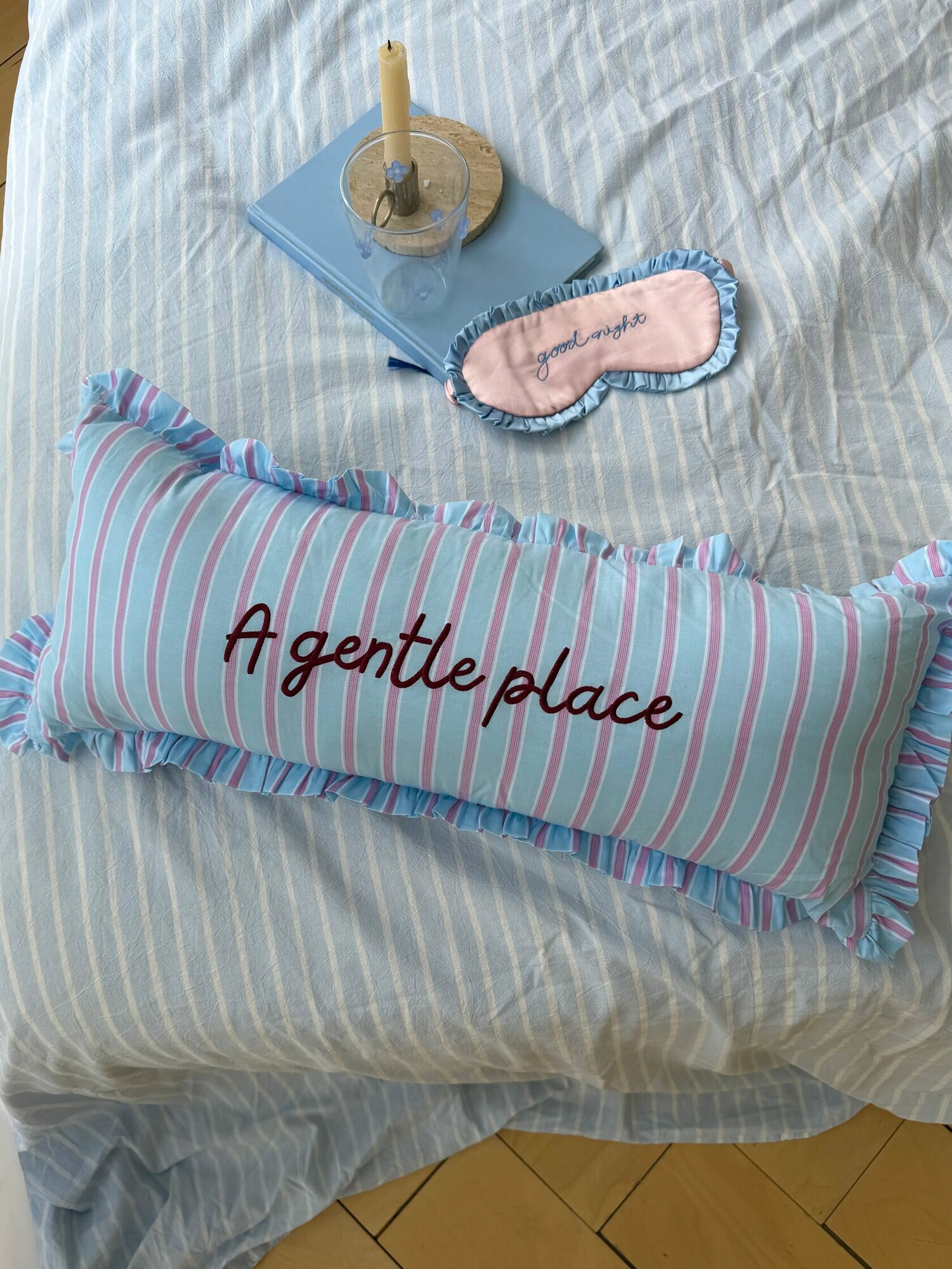 Подушка в голубую полоску с вышивкой A gentle place