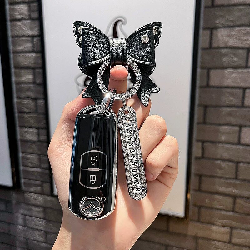 Автомобильный чехол для ключа Mazda Smart 2-кнопочный B-стиль черный корпус с жемчужным бантом и серебряной биркой