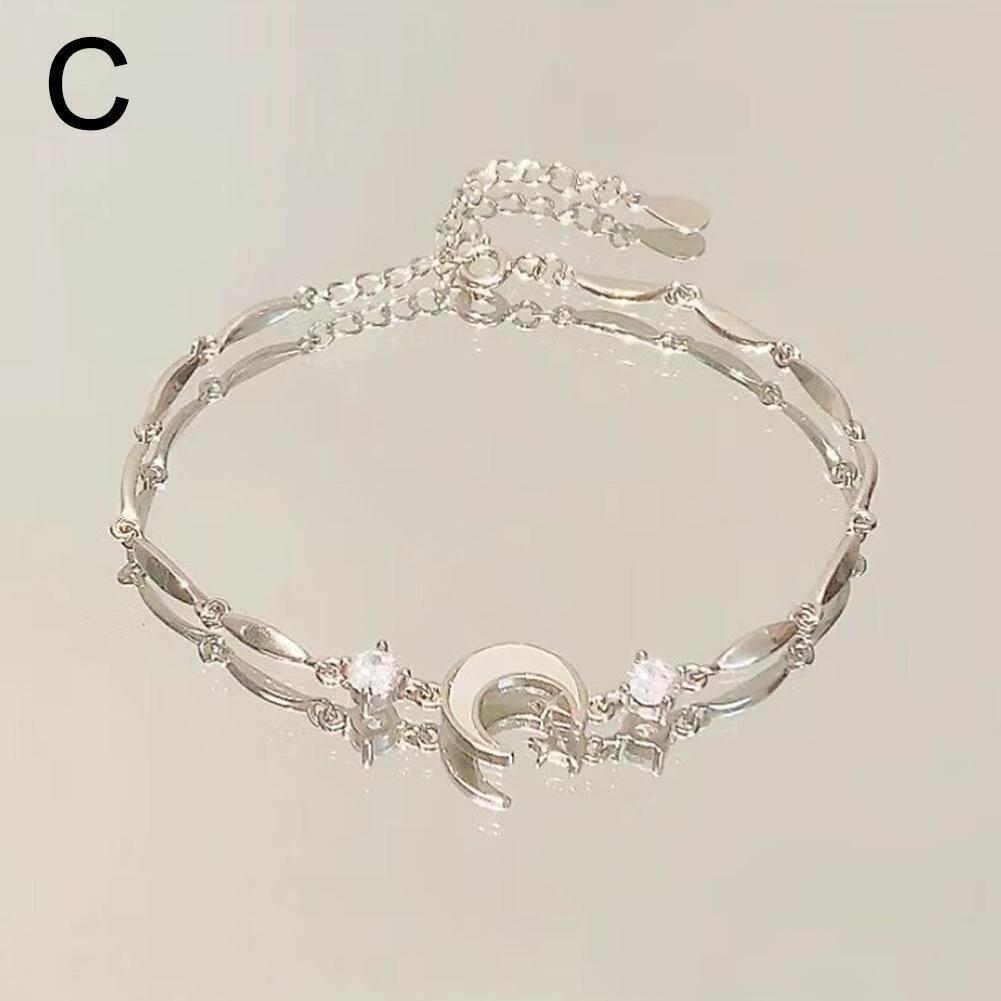 Хрустальный браслет с инкрустированными узорами, включающими луну, вишневые цветы и банты.