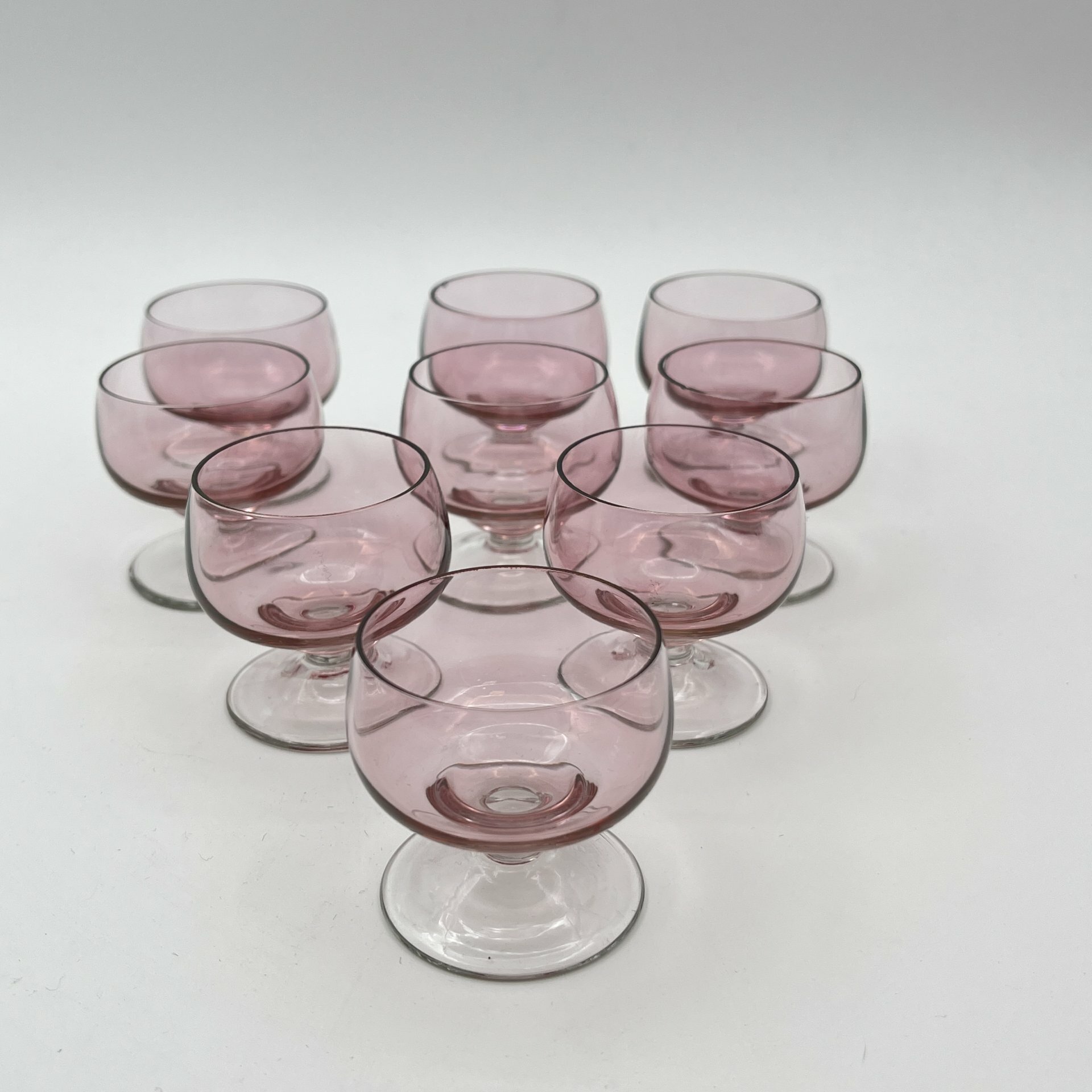 Набор из девяти рюмок нежно-розового оттенка, стекло, СССР, 1960-1990 гг.