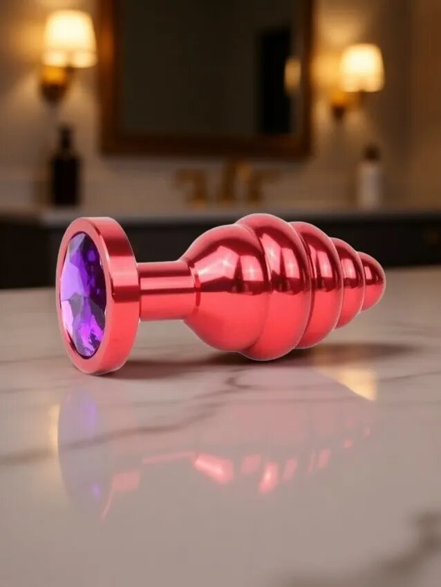 Анальная втулка ANAL JEWELRY PLUG Коническая ребристая красная с кристаллом фиолетового цвета - 8 см.