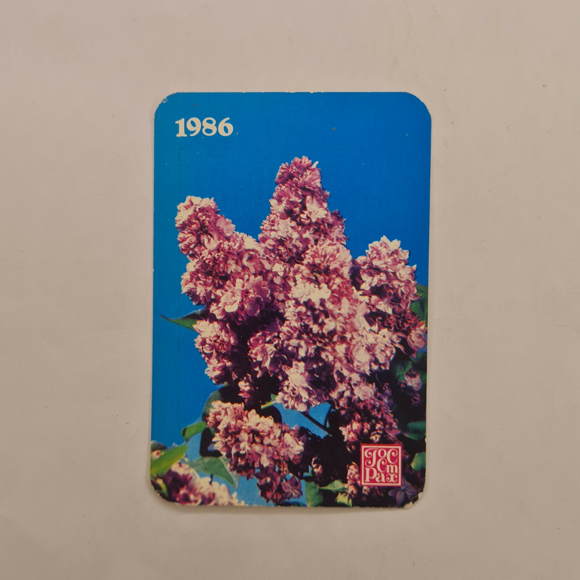 Карманный календарик 1986. Сирень на синем фоне, цветы весенние. Календарь винтажный