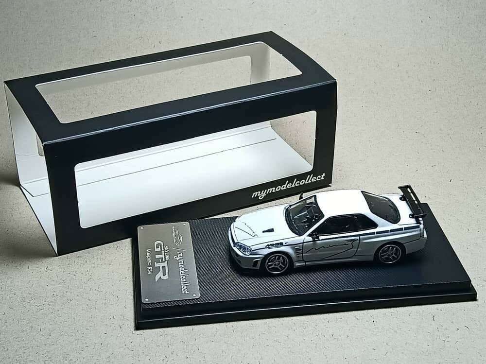 Коллекционная машинка Model Collect 1:64 Nissan Skyline GT-R Mk5 R34 V-SPEC-II White Mines