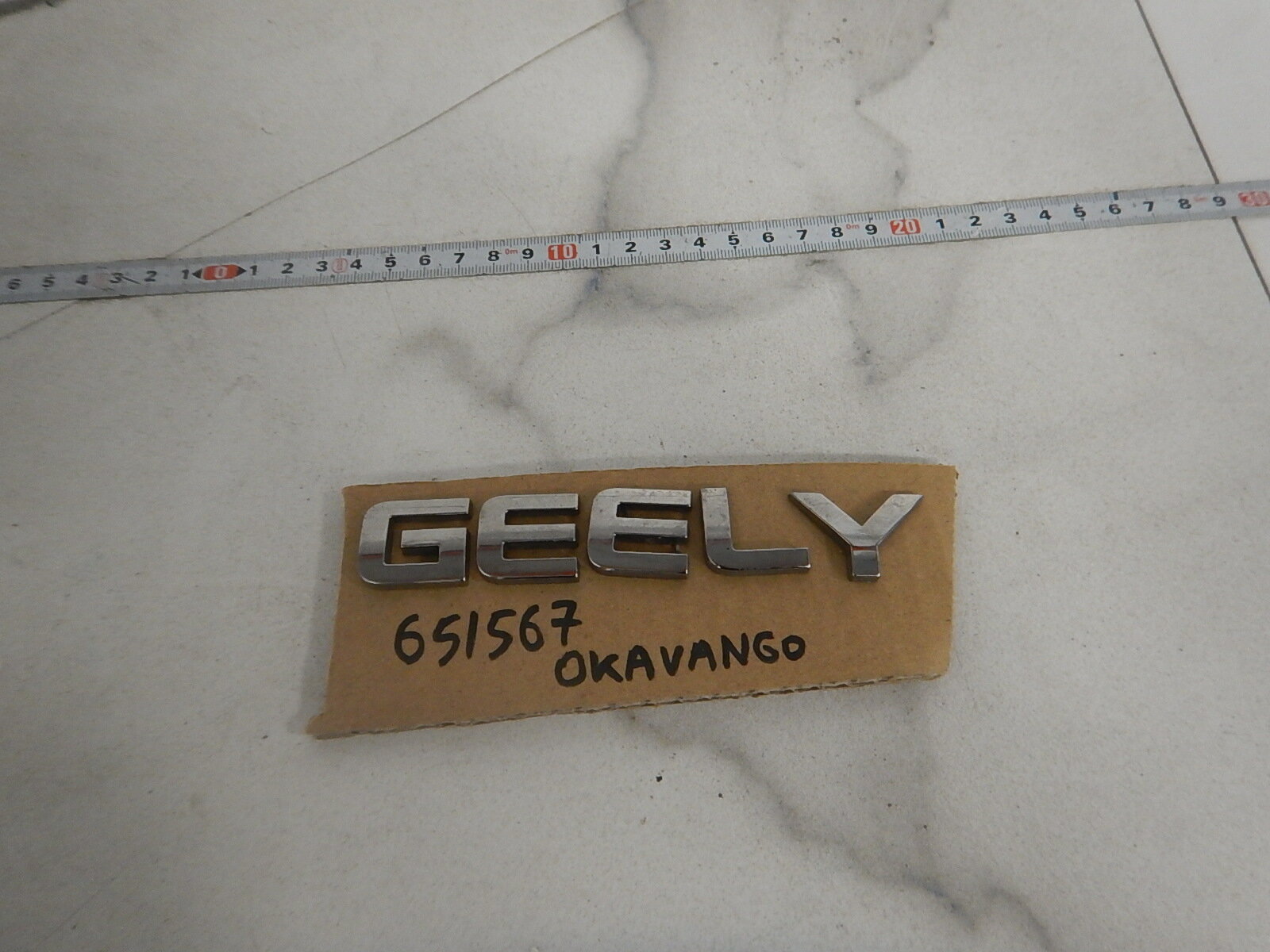 Б/У Эмблема на крышку багажника, Geely (Джили)-OKAVANGO (20-) GEELY OKAVANGO (20-) Потертости. 651567 GEELY арт. 6608129640