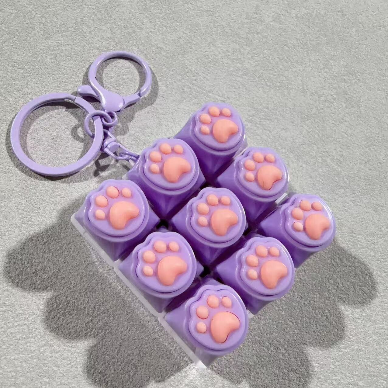 Многоцветная 9-кнопочная антистрессовая силиконовая игрушка-кнопка в виде кошачьей лапки с мультяшным рисунком для тестирования клавиатуры.