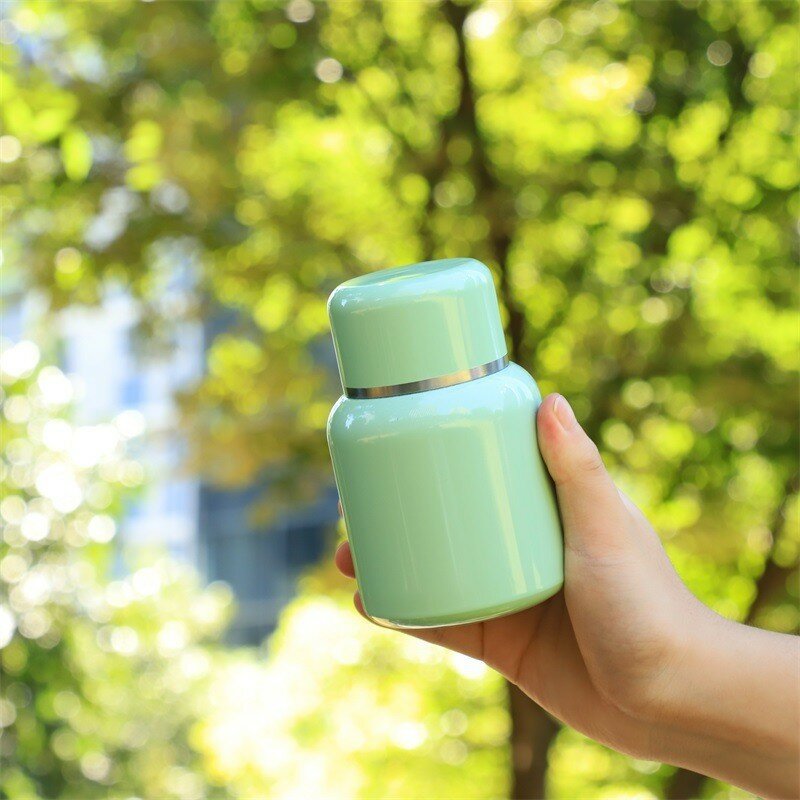 Stainless steel double layer insulated water bottle with tea strainer for commuting and gifts green