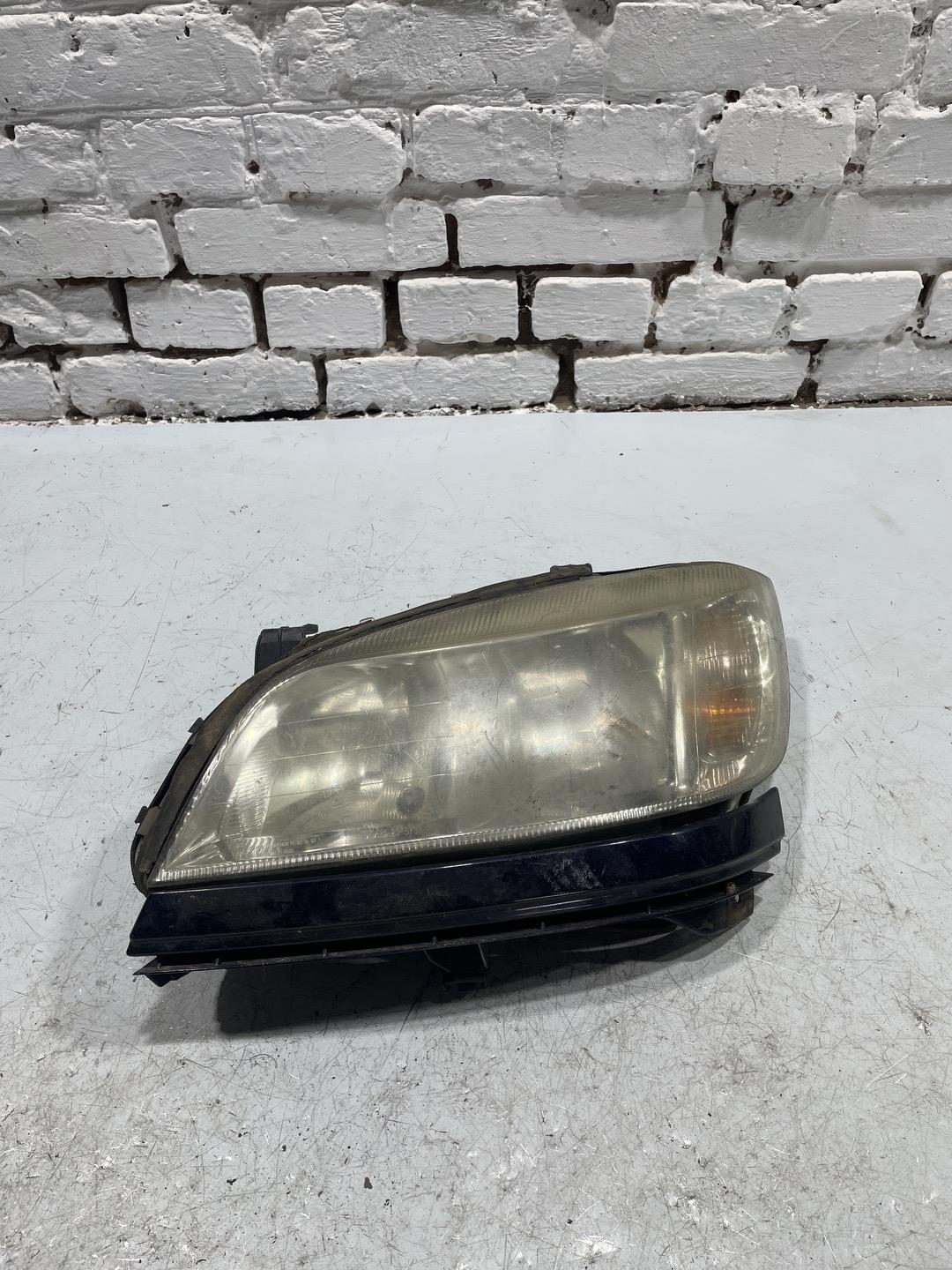 Фара левая Opel Zafira A (1999 - 2003) 90582021