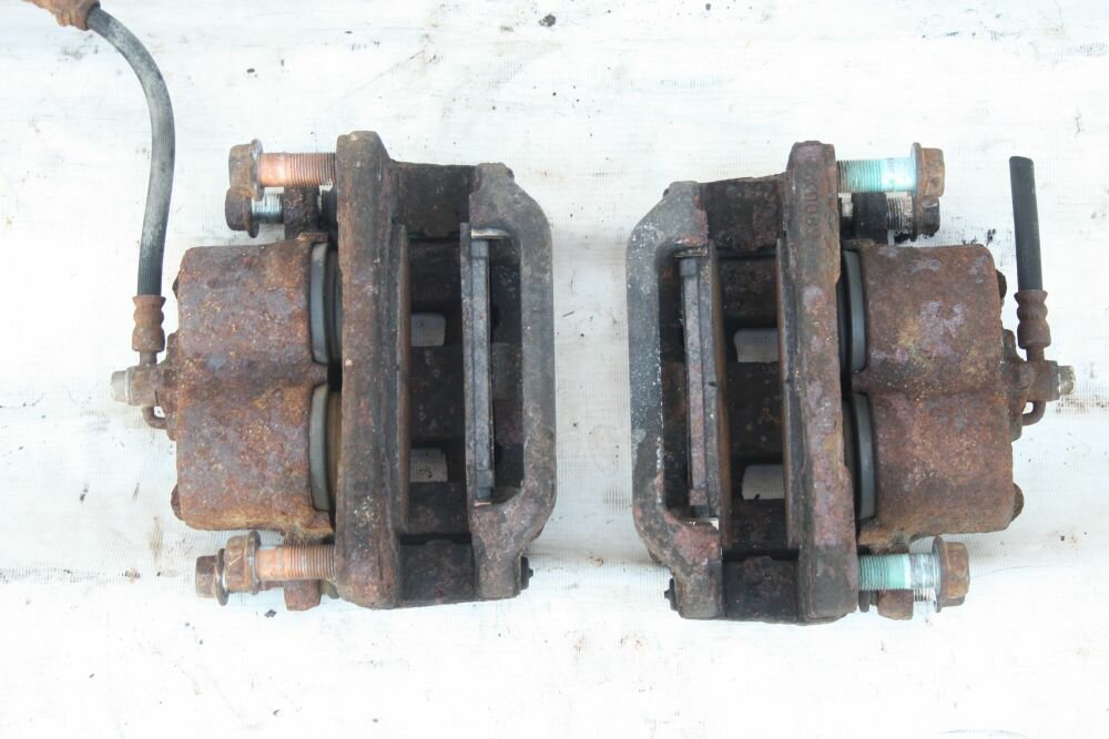 Суппорт тормозной передний левый Mazda CX7 L206-33-990B