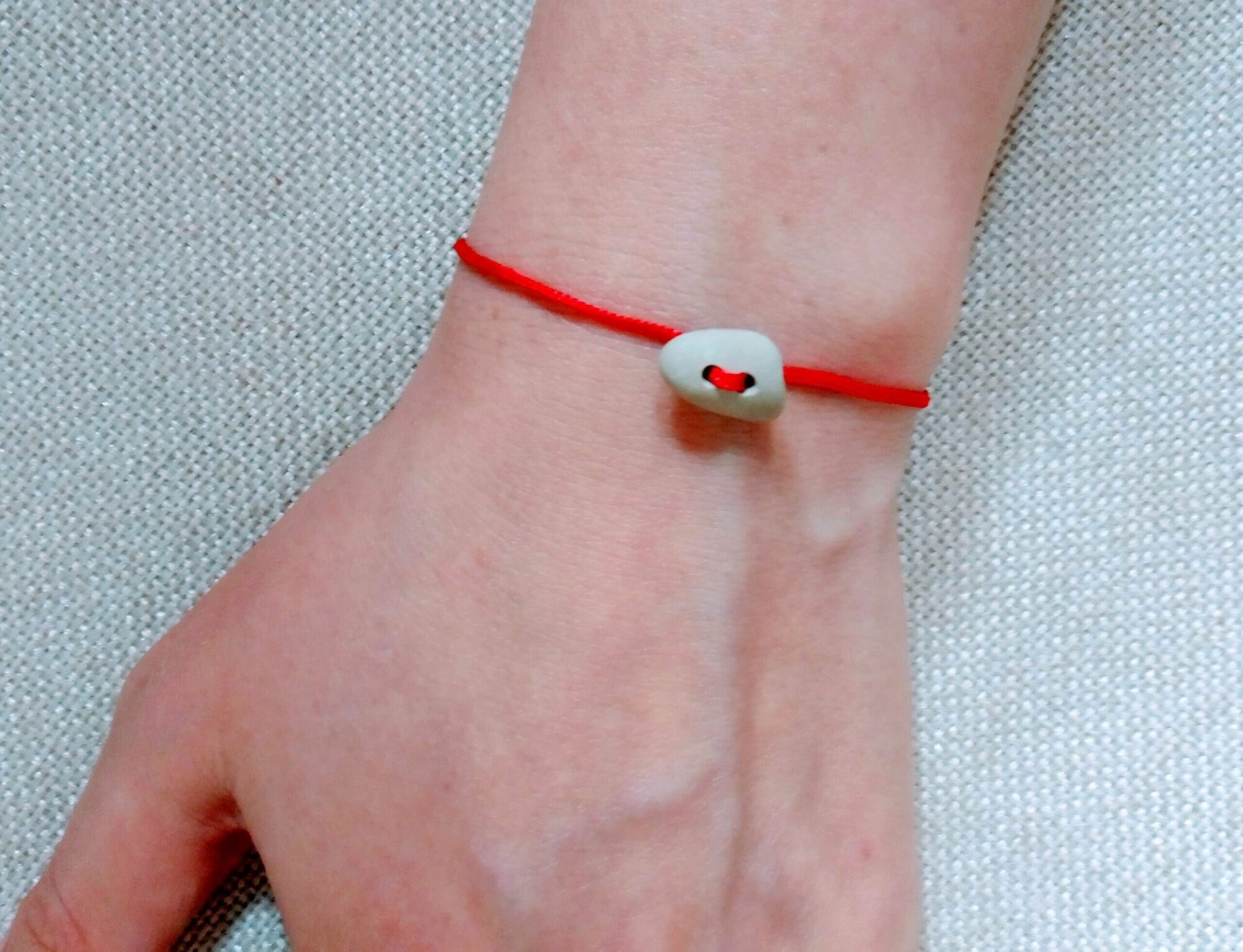 Красная нить на запястье с природным камнем (от сглаза и порчи)