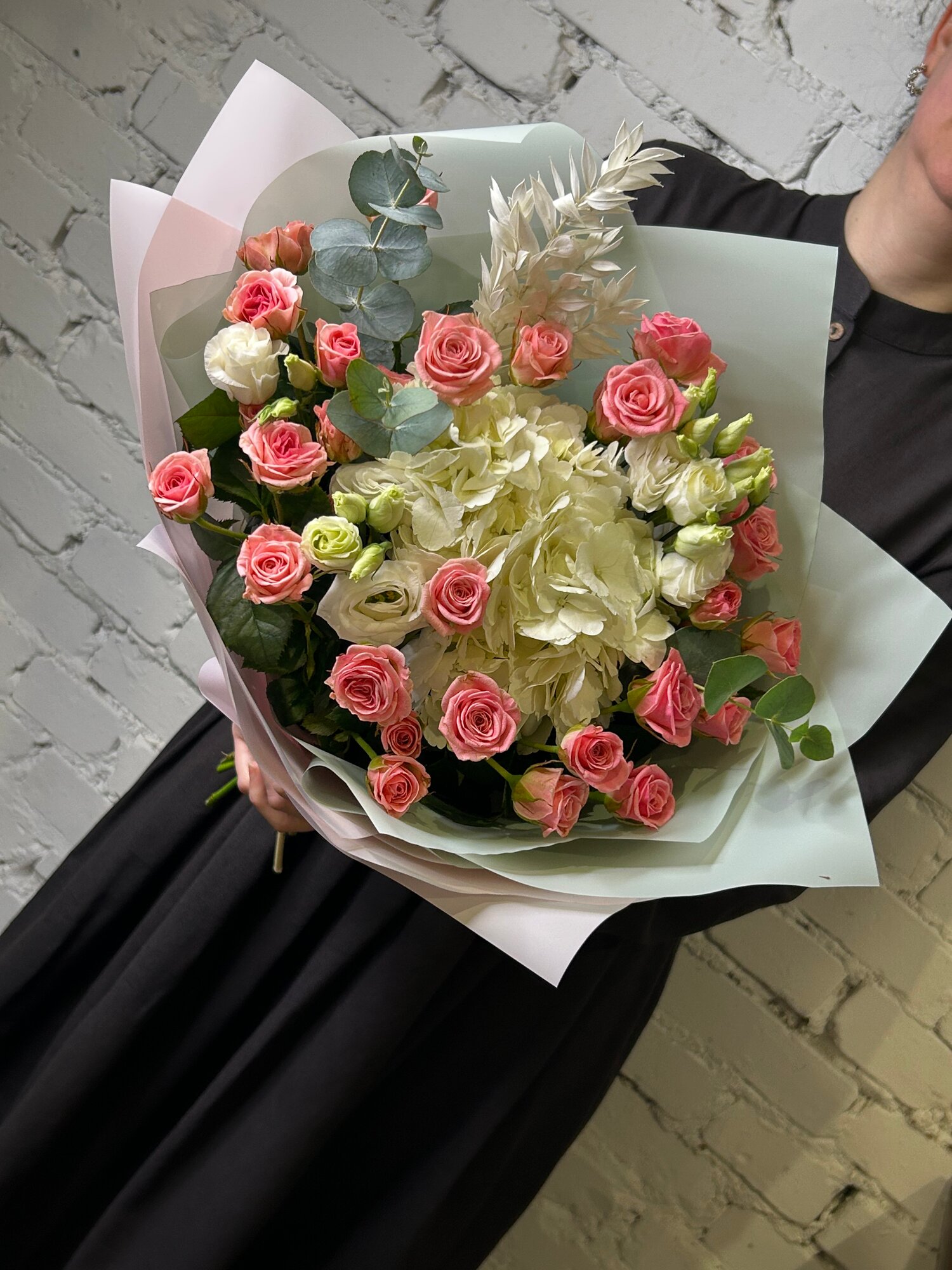 Букет свежесрезанных цветов из гортензии, кустовых роз, эустомы и ароматного эвкалипта в дизайнерской упаковки.