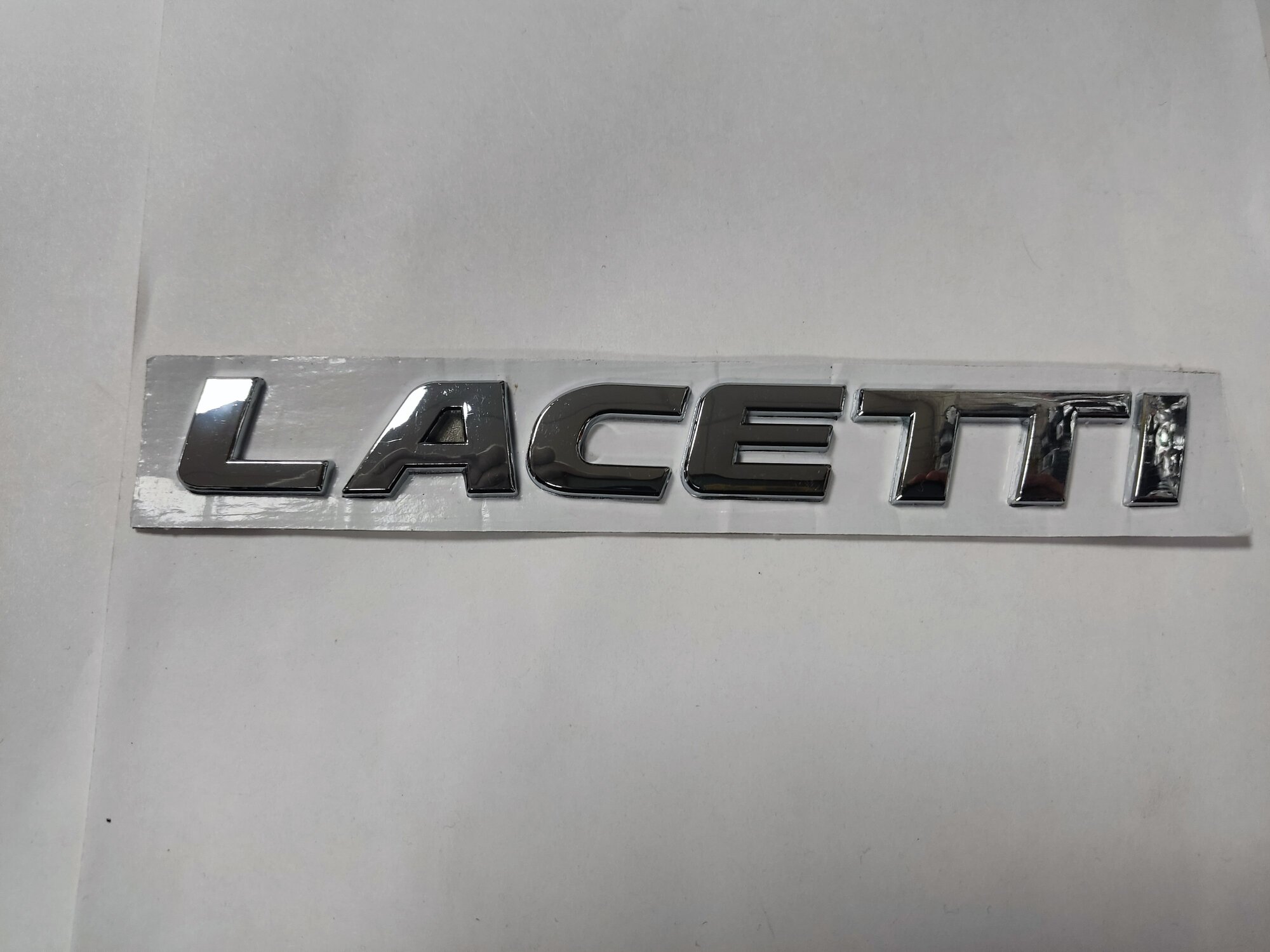 Шильдик Chevrolet Lacetti, углепластик, самоклеящийся, хром, 17см, 1 шт