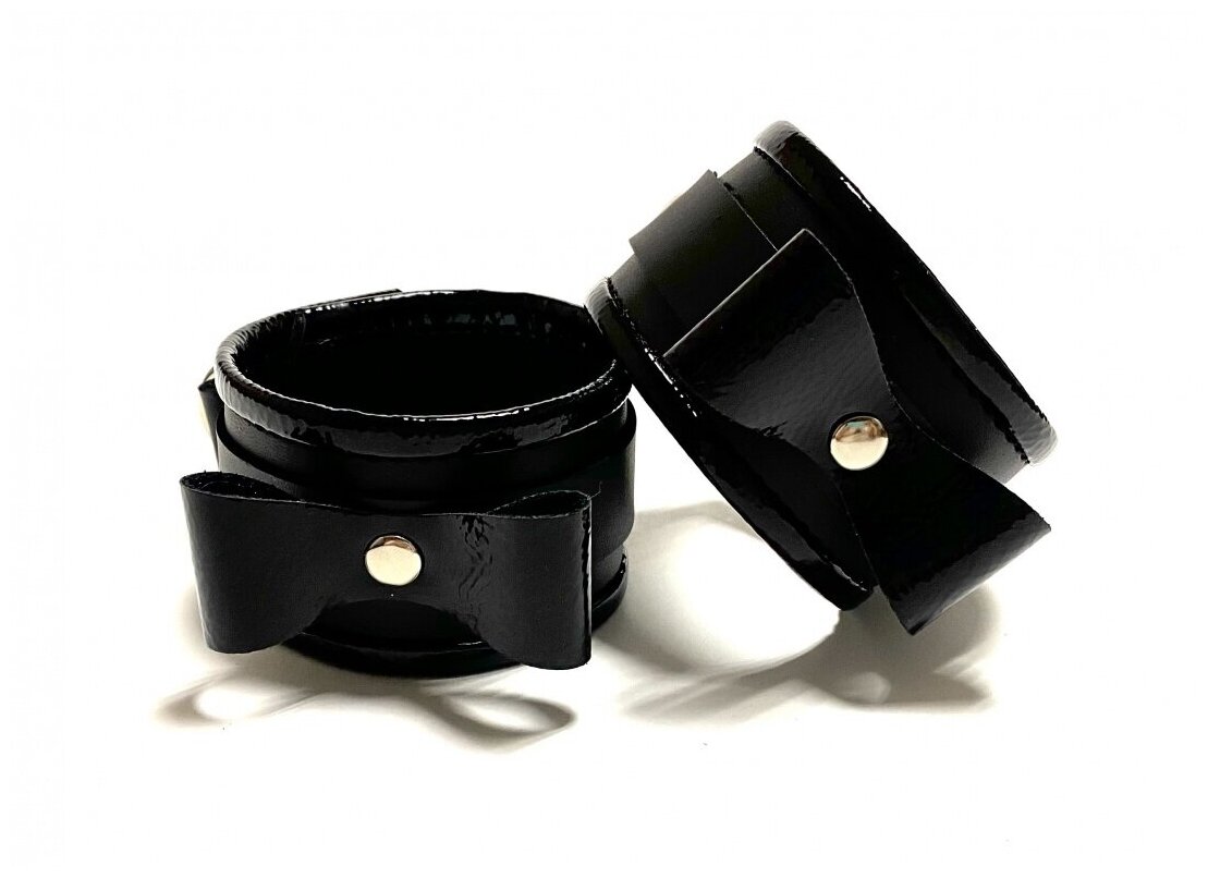 Наручники с бантиками БДСМ Арсенал эко-кожа черные регулируемый размер до 25 см