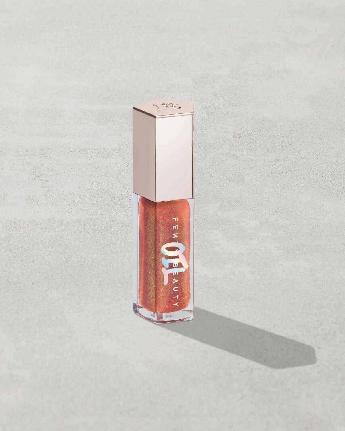 Fenty Beauty Мерцающее блеск масло для губ Gloss Bomb Oil Luminizing Lip Oil N' Gloss, Fenty Glow, 9 мл