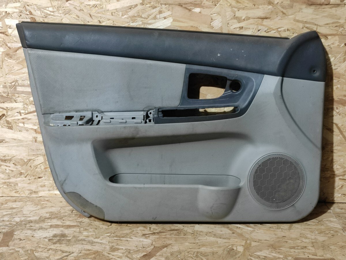 Обшивка двери передней левой KIA Cerato 2004-2008 823012F03052