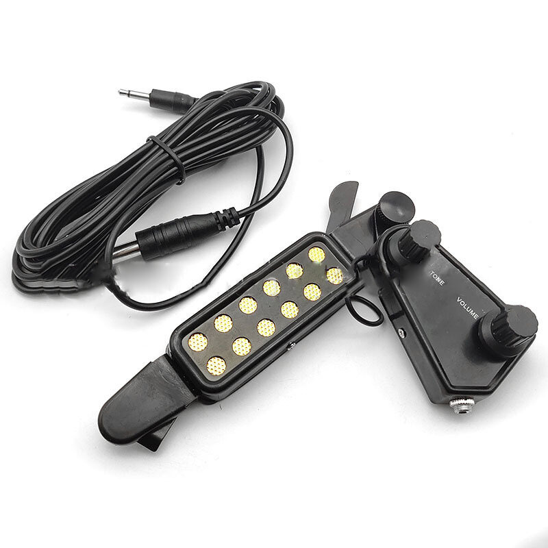 Звукосниматель для акустической гитары, устанавливаемый в резонаторное отверстие, с регулировкой громкости и тембра. Отверстие для регулировки.