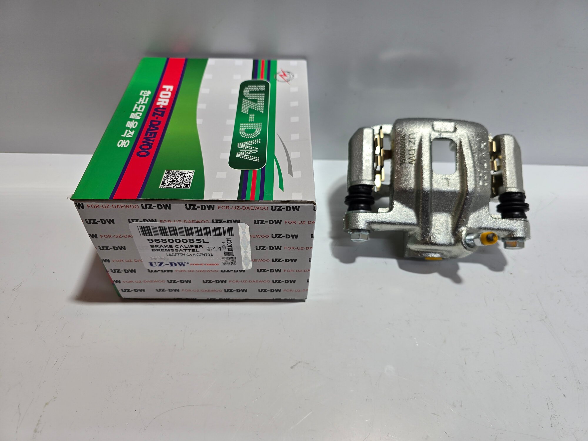 Суппорт задний левый в сборе со скобой Лачетти, Джентра, Нубира