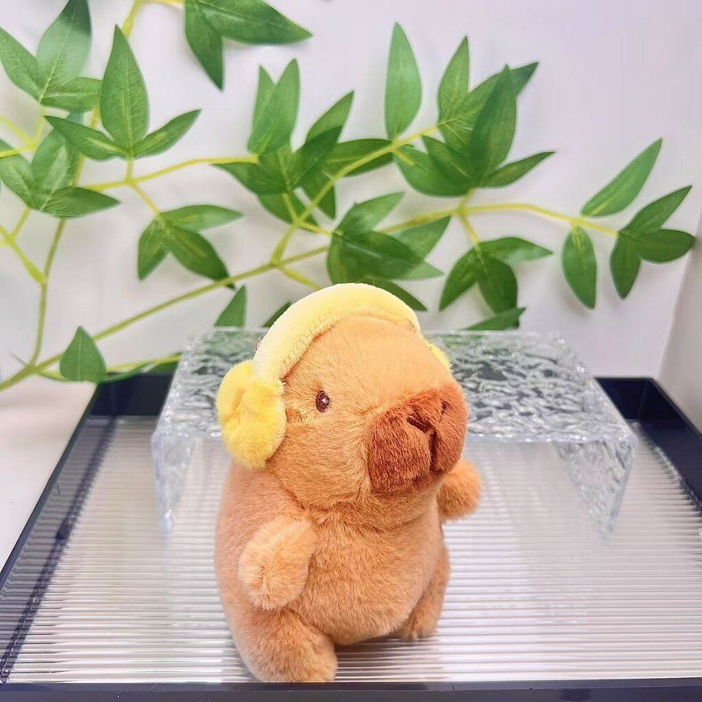 Fun and plush capybara stuffed animal with various headphone colors for kids and adults
