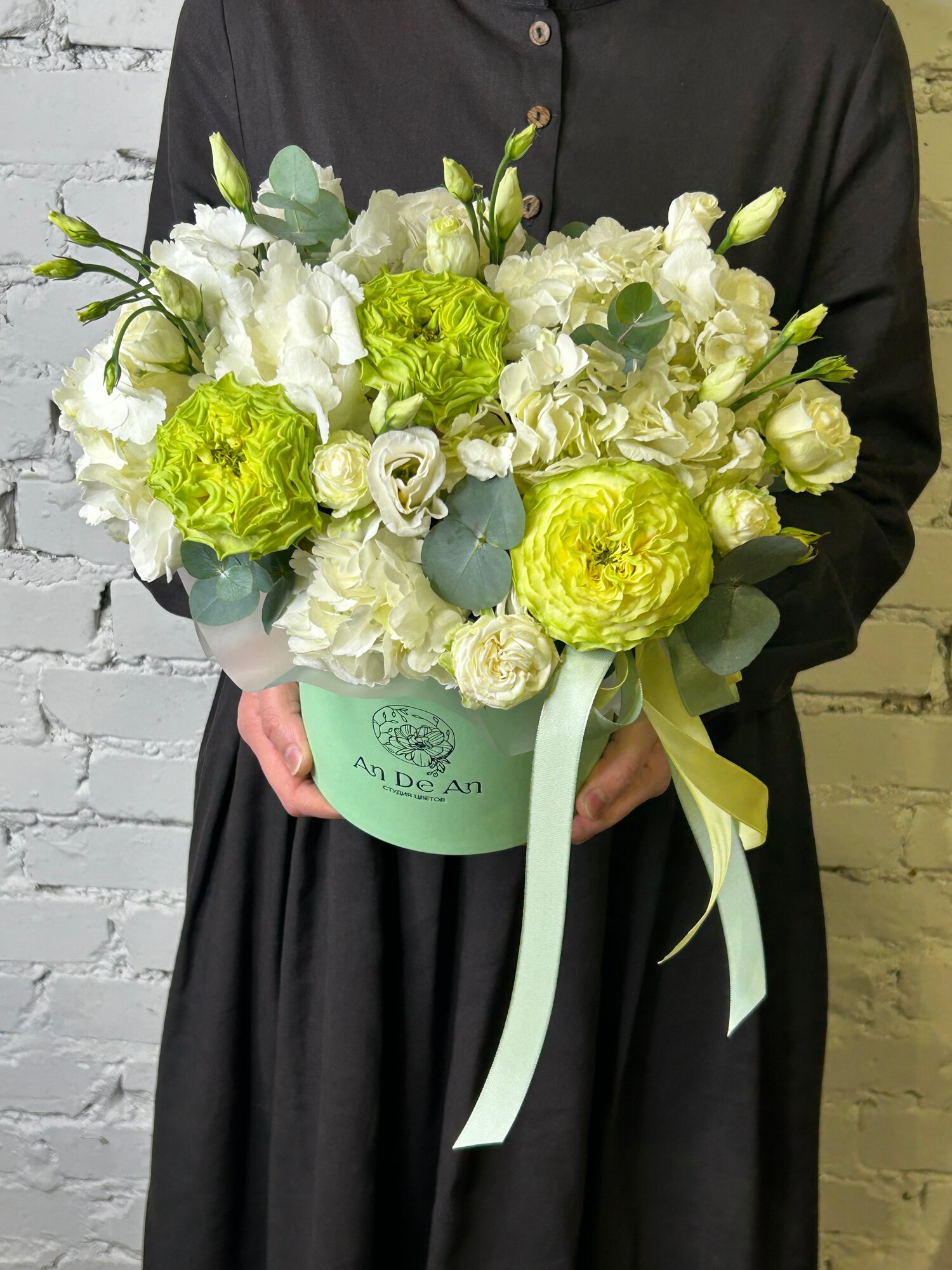 Коробка свежесрезанных цветов из кустовых роз, гортензии, эустомы, пионовидных роз и ароматного эвкалипта.