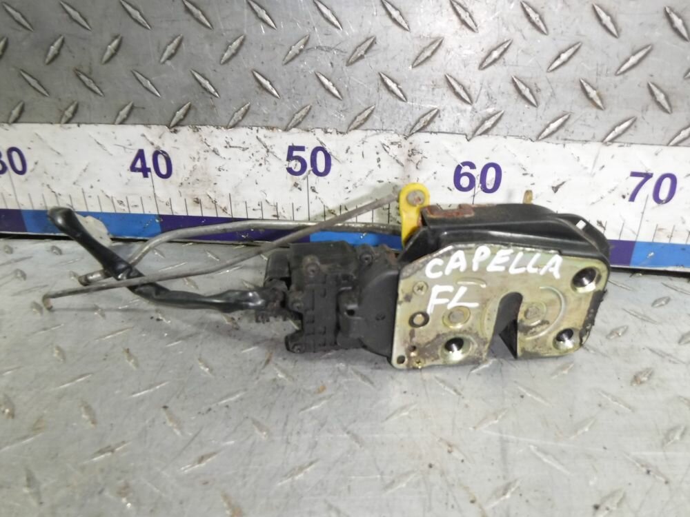 Замок двери передней левой Mazda Capella G06T59310C