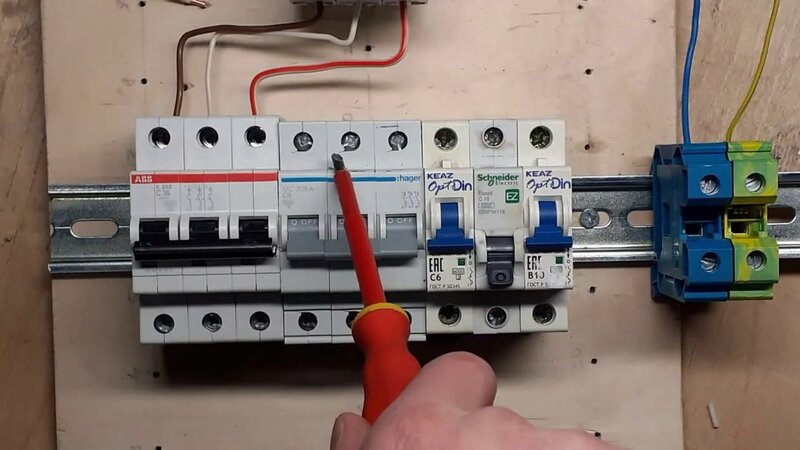 Assembling a three-phase panel. Connecting 380 circuit breakers ...
